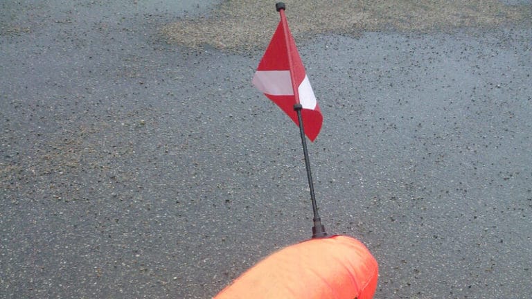 Red Flag With Diagonal White Stripe - What Does It Mean?